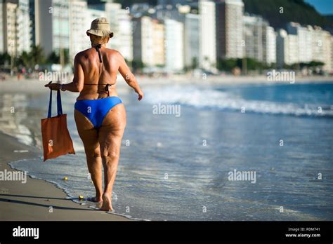 Bright Scenic Morning View Of Copacabana Beach With Woman Walking Along