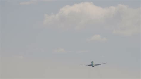 Passenger Airplane Is Flying Far Away Departing Aircraft In The Air