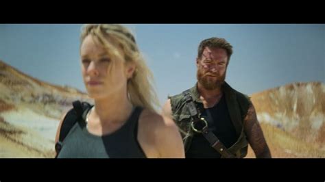 A Man And Woman Are Walking In The Desert With No One On Their Back