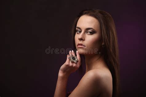 Beautiful Brunette Woman With Professional Makeup And Hairstyle Showing
