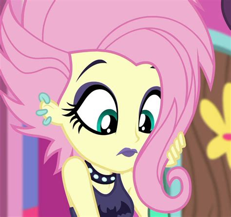 The Pinkie Is Holding An Umbrella In Her Hand And Looking At Something