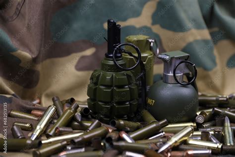 Different Types Of Ammunition And Grenades On A Camouflage Background