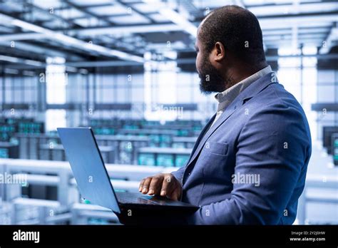 Programmer In Data Center Implementing Backup Solutions To Protect Against Infrastructure Data