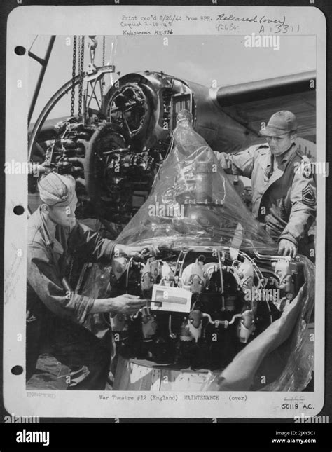Two Crew Members Of A Consolidated B 24 Liberator Prepare To Make An