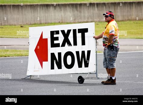 Man With Exit Sign Stock Photo Alamy