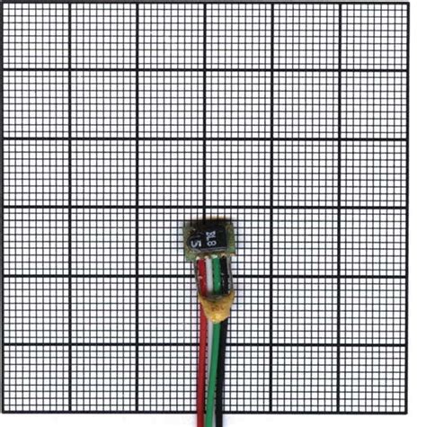 Temperature And Humidity Sensor Sht15 Placed On Millimeters Scaled