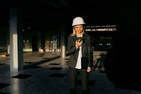 Young Architect Woman Smiling Happy Using Smartphone In Office