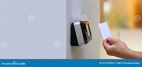 Close Up Hand Security Man Using ID Card Scanning At The Access Control System For Identity