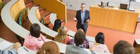 Elegant Teacher With Students Sitting At The College Lecture Hall Macc