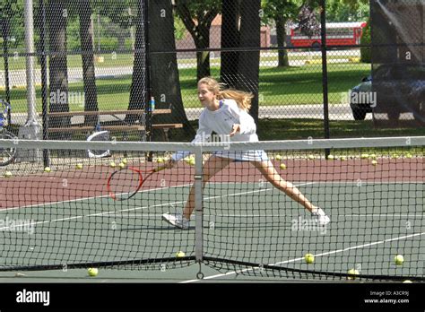 Teenage Female Student Playing Tennis At An After School Club In