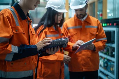 Group Of Robotics Engineers Working With Programming And Manipulating
