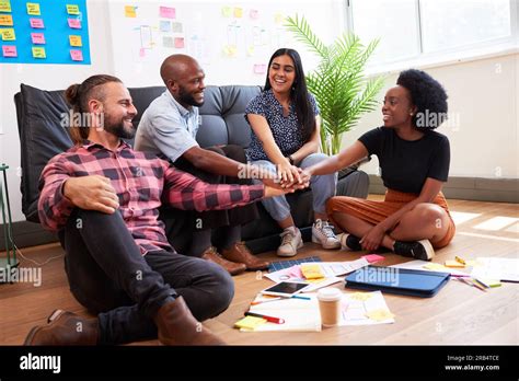 Multiracial Group Of Colleagues Put Hands Together In Stack Celebrate