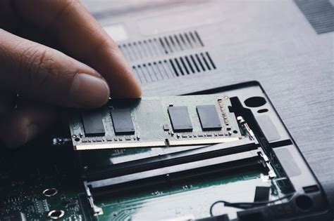 Premium Photo Technician Install New Ram Randomaccess Memory To Memory Slot On Laptop Motherboard