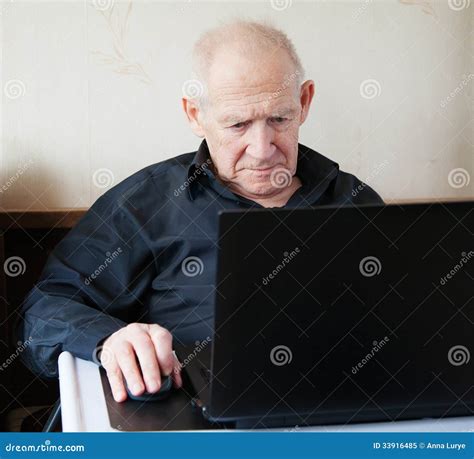 Serious Old Man Working On A Computer Royalty Free Stock Photo Image 33916485