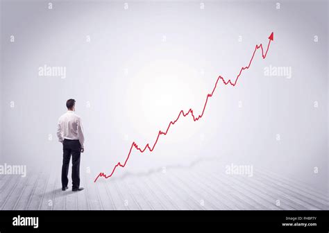 Standing Businessman With Red Graph Arrow Stock Photo Alamy