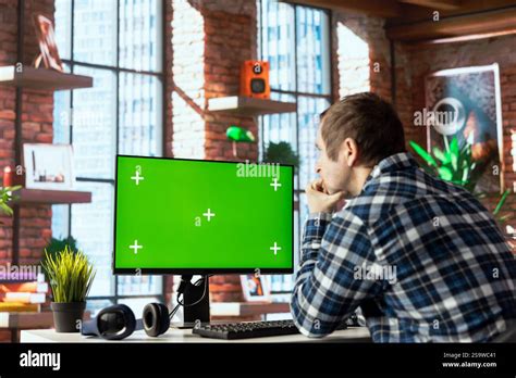 Man In Modern Workspace Using Chroma Key Pc Monitor To Answer Emails