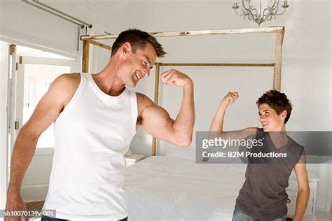 Dad And Boy Flexing Photos And Premium High Res Pictures Getty Images