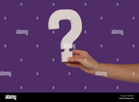 Female Hand Holding Up A Question Mark From The Ri Stock Photo Alamy