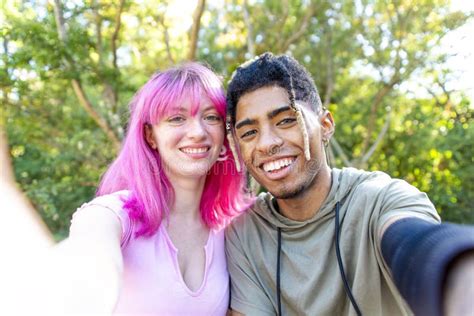 Alternative Diverse Couple Hanging Out In A Park Making A Pov Selfie