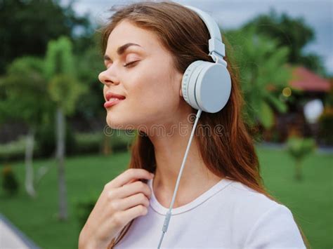 Woman Portrait In Headphones Happiness Smile With Her Eyes Closed In A