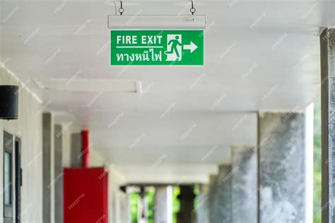 Premium Photo Fire Exit Sign On The Ceiling Of A Building Fire Exit Signfire Fighting