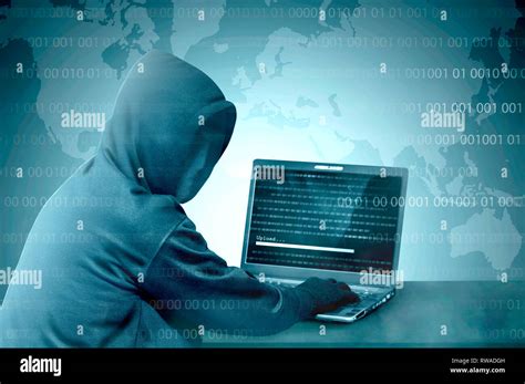Hacker In Black Hoodie Using Laptop On The Desk To Hacking System With