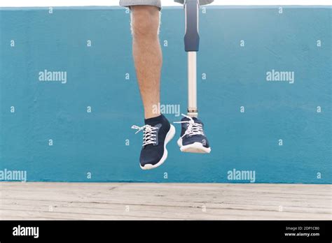 Disabled Man Jumping Against Blue Wall Stock Photo Alamy