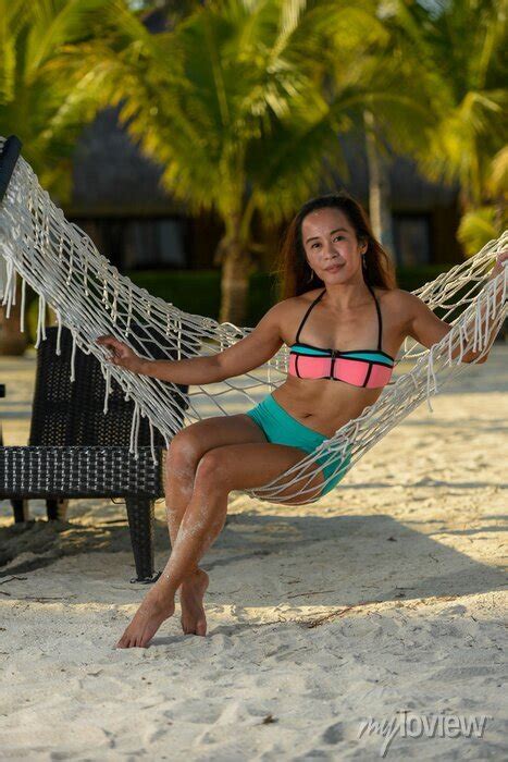 Filipino Girl In Bikini Lounging And Posing At Tropical Beach Wall