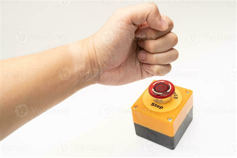 Stop Button And The Hand Of Worker About To Press It Emergency Stop