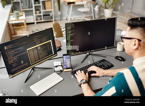 High Angle Portrait Of It Developer Typing On Keyboard With Programming