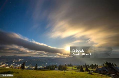 여름 밤 산 파노라마입니다 푸른 잔디 산 청소 파란 저녁 하늘 복사 공간 배경에 스프루 스 나무 계곡 아래 이동 자동차와 주거 조명을 가진 밝은도로 0명에 대한 스톡 사진