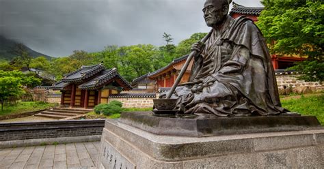 건물 앞에서 지팡이를 들고 있는 남자의 동상 사진 Unsplash의 전통적 이미지