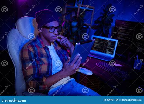 Photo Of Intelligent Hacker Sitting Chair Use Tablet Operating Database Evening Loft Office