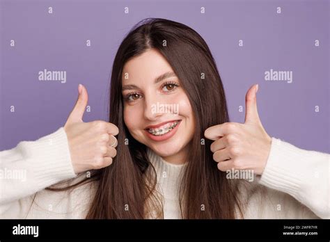 Portrait Of A Girl With Braces Woman Happy With Braces Shows Ok Sign Stock Photo Alamy