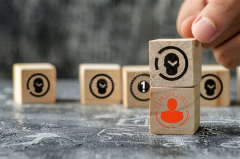 Hand Stacking Wooden Blocks With Icons Representing Teamwork Leadership And Business Strategy