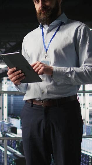Vertical Portrait Of Smiling Engineer In Data Center Monitoring Neural