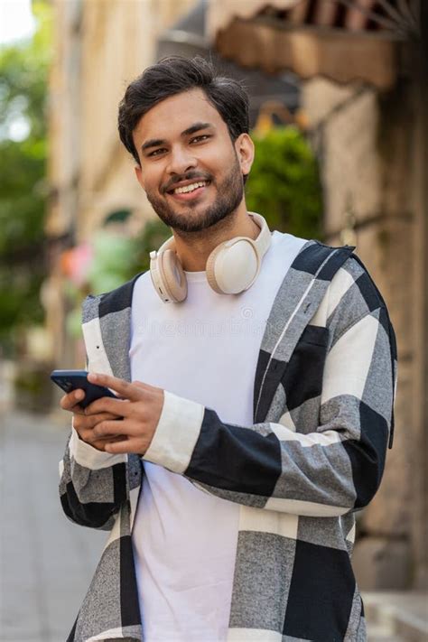 Indian Man Using Smartphone Typing Text Messages In Social Media