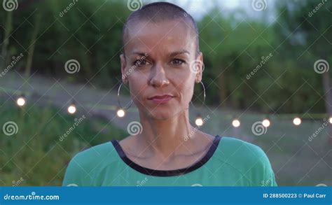 Portrait Of A Woman With A Shaved Head Looking At The Camera In Slow
