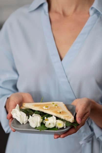 Free Photo Front View Adult Holding Plate With Sandwich