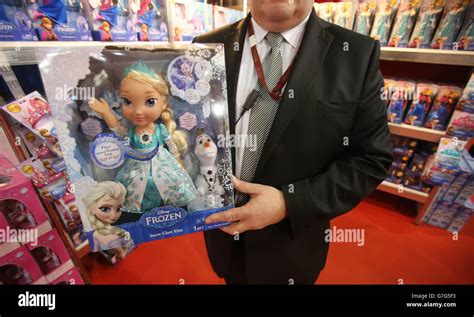 A Security Guard Holds A Snow Glow Elsa Doll From The Disney Film