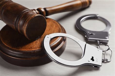 Judge`s Gavel And Handcuffs On White Wooden Background Criminal Law