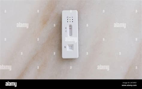 A Single Test Kit Placed On A Marble Surface With Copy Space On The Left And Right Side Stock