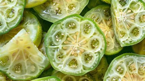 Premium Photo Slices Of A Green Exotic Fruit With Visible Seeds The Fruit Is Round And Has A