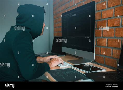 Hacker In The Hood Working With Computer With Hacking Breaking Into