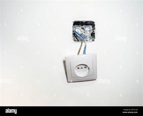 Broken Electrical Socket On The Wall Disassembled Device White Wall With A Socket Pulled Out
