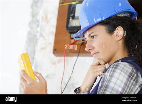 A Woman Measuring Electrical Current Stock Photo Alamy