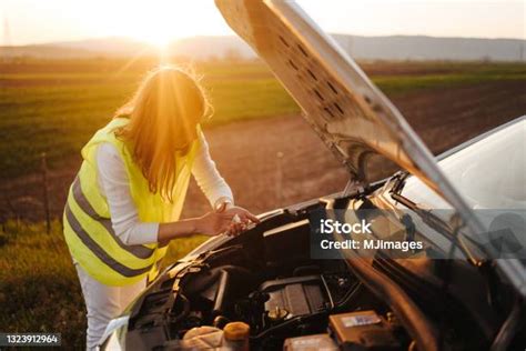 젊은 여성은 자동차 후드를 열고 고속도로 고장 후 그녀의 차를 수리하려고합니다 고속도로에서 자동차 고장 걱정하는에 대한 스톡 사진 및 기타 이미지 Istock