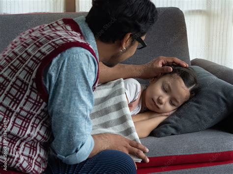 Father Lovingly Tuck Cute Little Daughter To Sleep On Sofa In The Living Room At Home Daddy