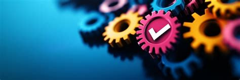 A Group Of Colorful Gears Interlocked With A Checkmark Symbol On A Pink Gear Representing Suc