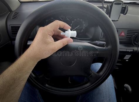 Driver Holds Breathalyzer Mouthpiece Sitting In The Car Stock Photo
